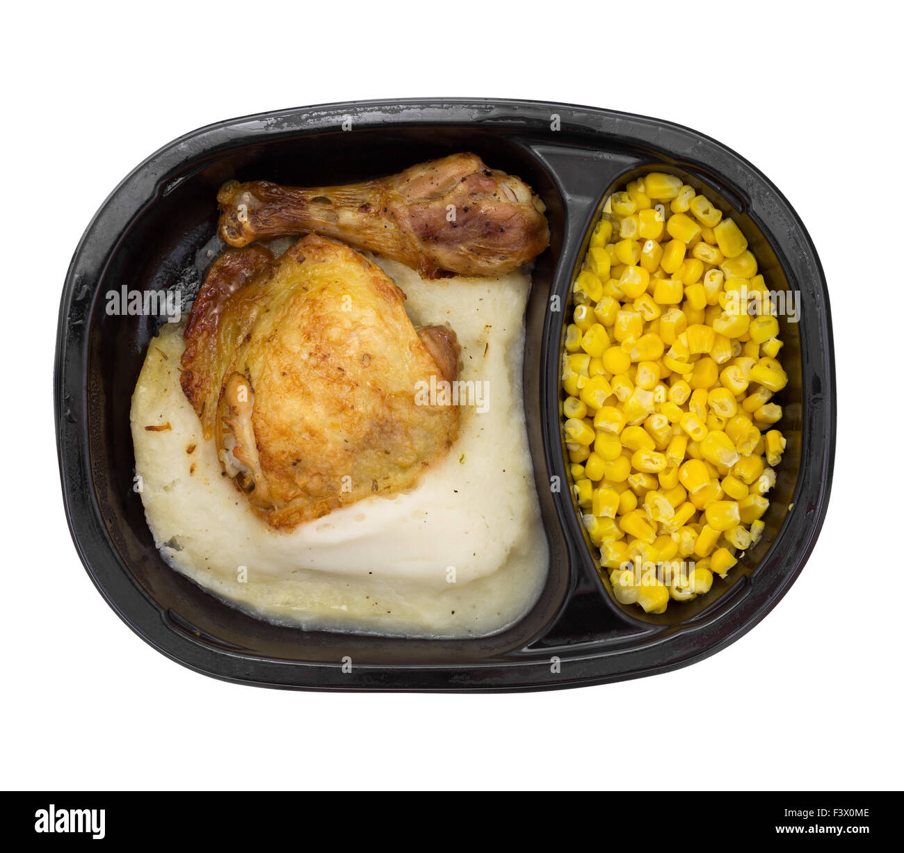 Top view of a microwaved TV dinner of roasted chicken with mashed ...
