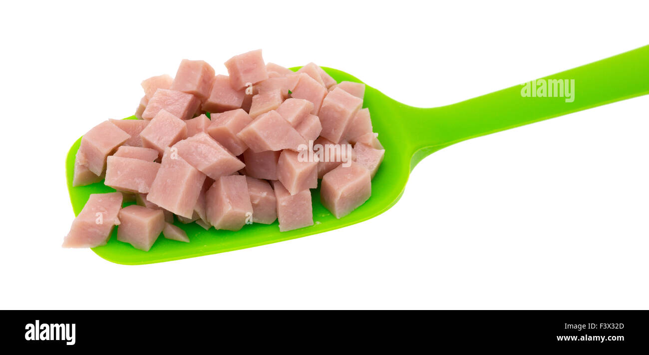 A portion of diced ham on a green spoon on a white background Stock ...