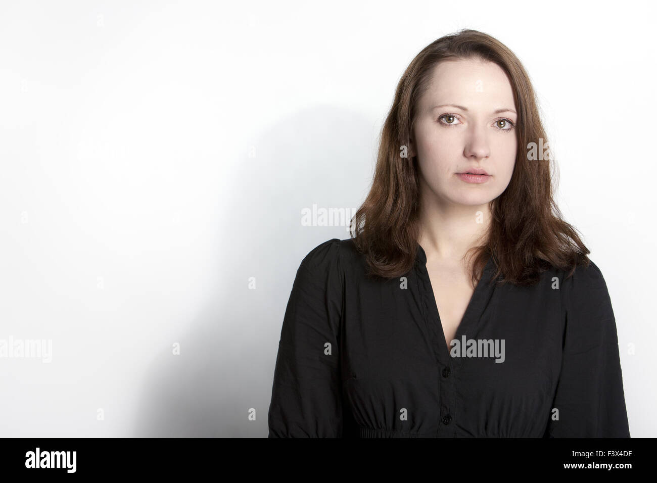Young, serious-looking woman Stock Photo - Alamy