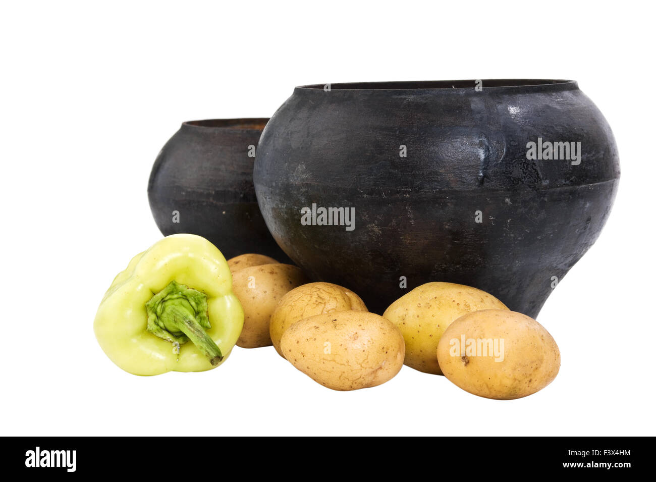cast iron pot with a potato Stock Photo - Alamy