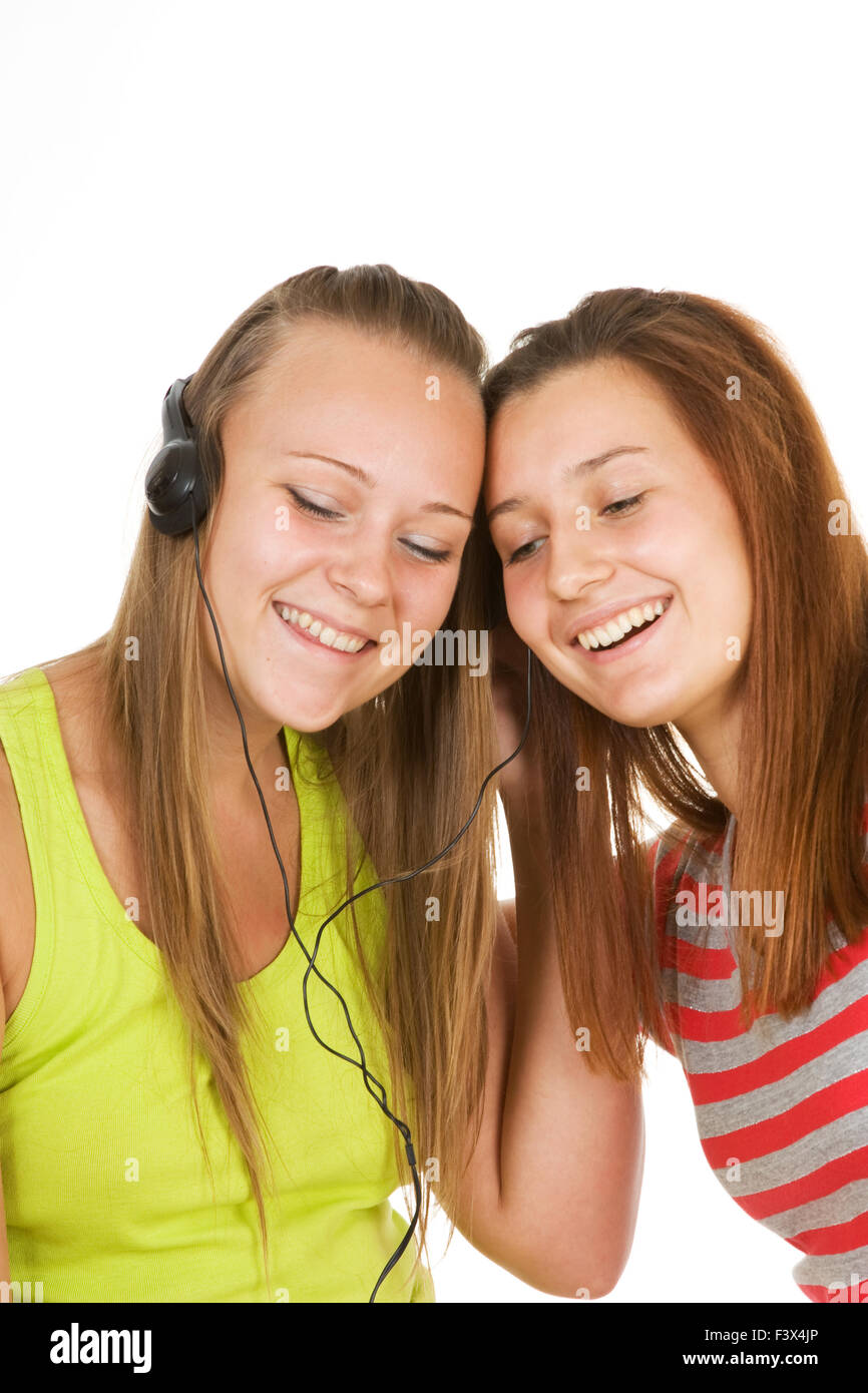 Two teenage girls listening to music Stock Photo - Alamy
