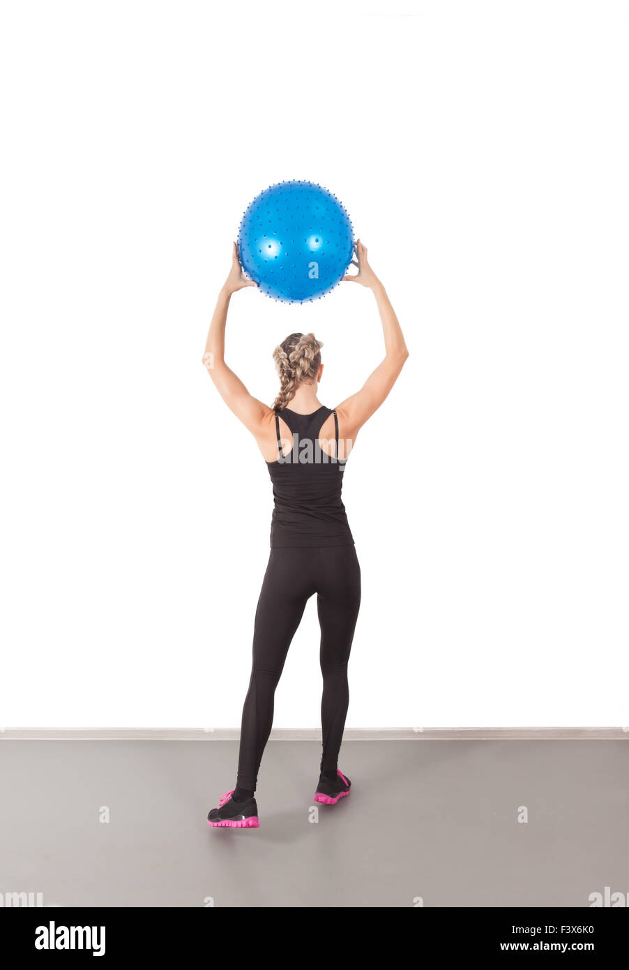 Athletic young woman with blue ball Stock Photo - Alamy