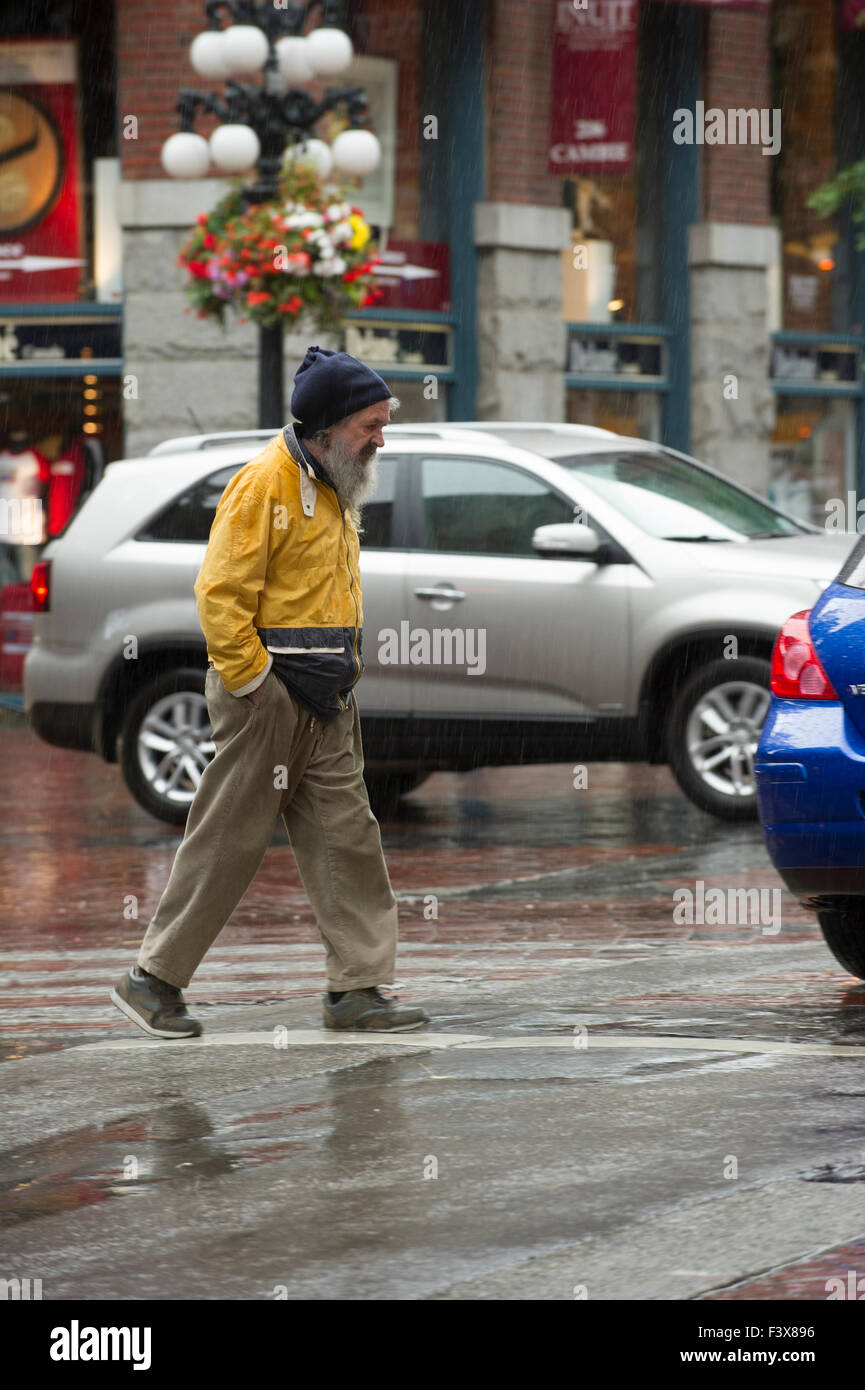 Older man crossing the street in the rain, Vancouver Stock Photo - Alamy