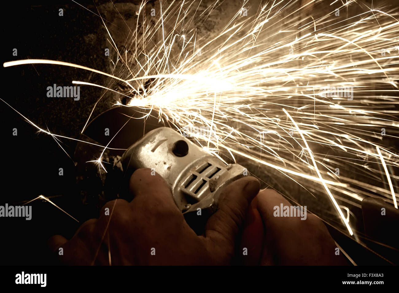 Sparks from a worker grinding steel Stock Photo - Alamy