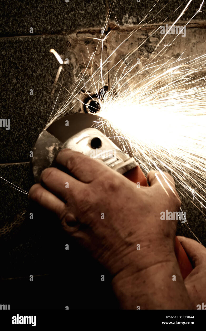 Sparks from a worker grinding steel Stock Photo - Alamy