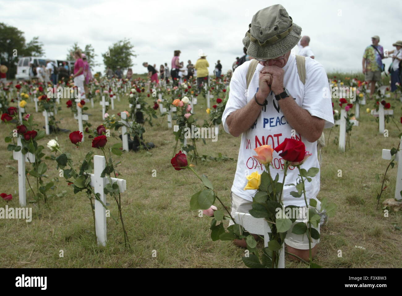 Billy Kelly, who is a veteran, pays his respects at a cross at Camp ...