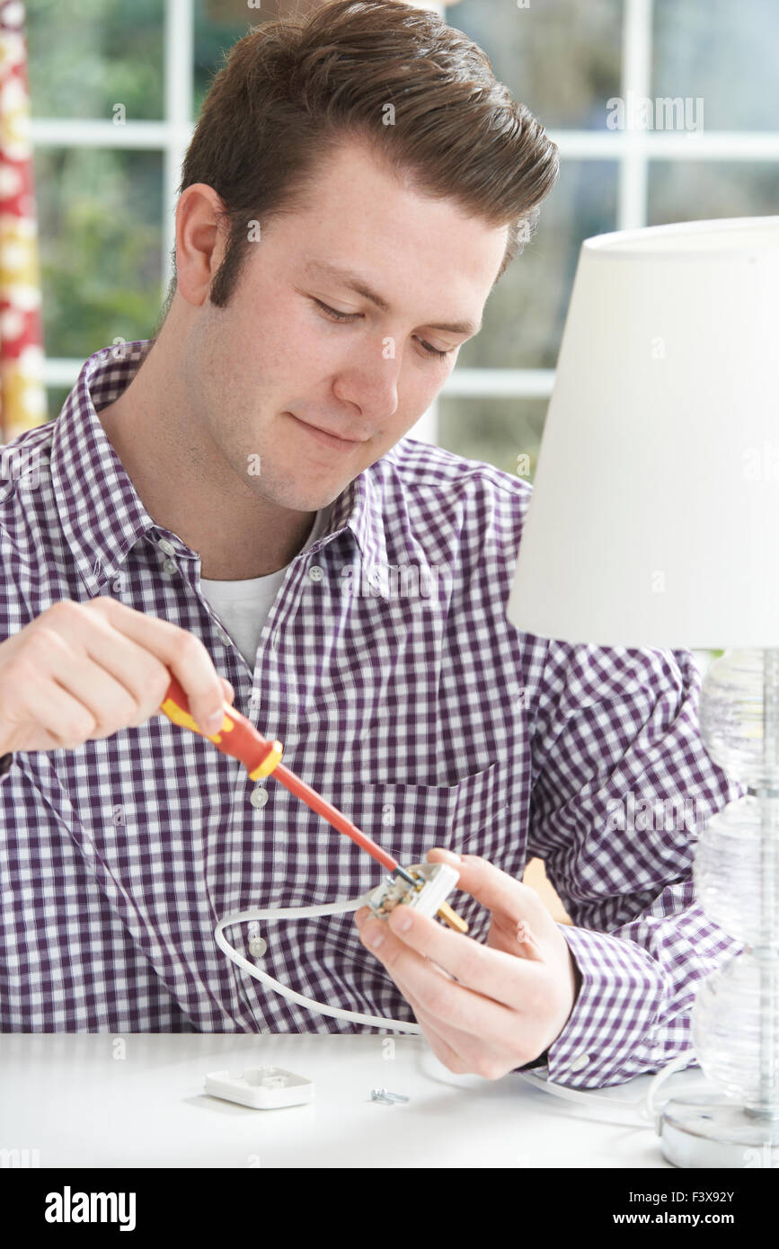 Man Wiring Electrical Plug On Lamp At Home Stock Photo - Alamy