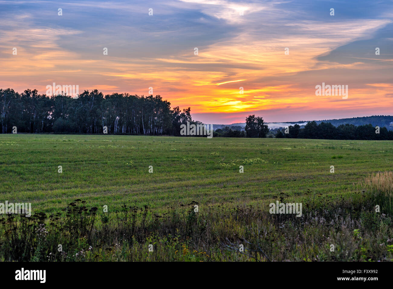Sunset over landscape Stock Photo - Alamy