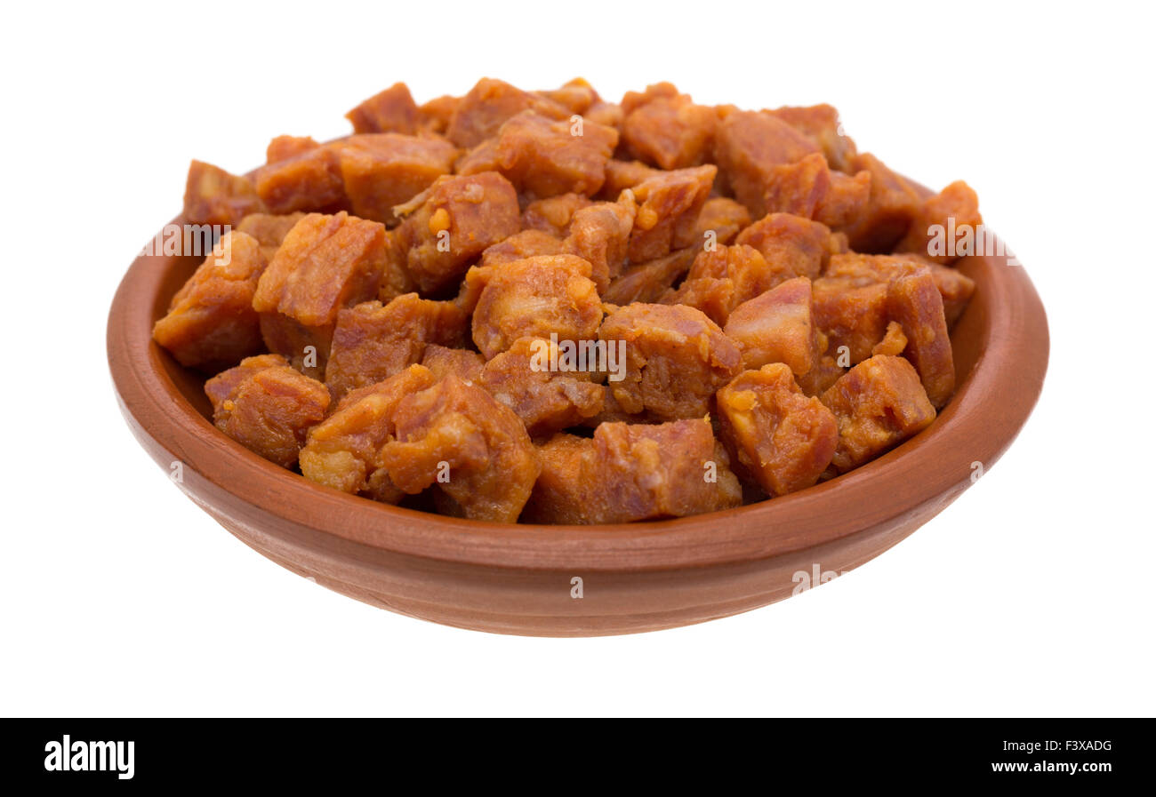 A small bowl of pepperoni pizza topping that has been chopped into ...