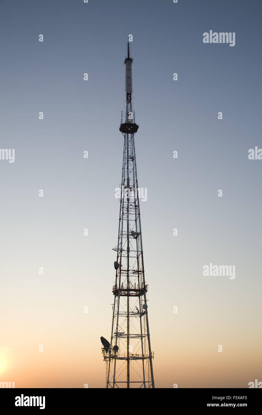 communication tower at sunset with cityscape Stock Photo - Alamy