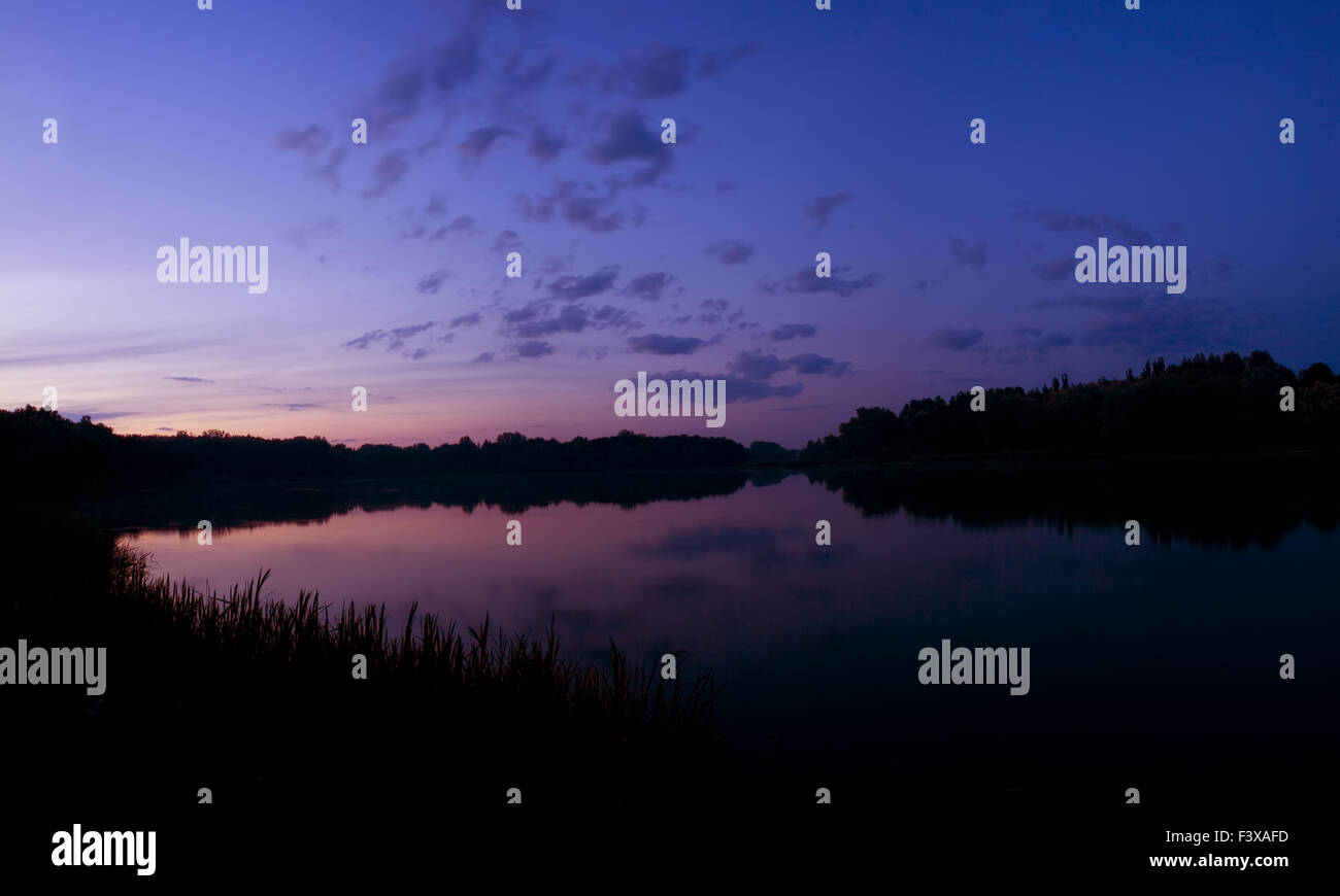 Romantic sunset on the lake with fog Stock Photo - Alamy