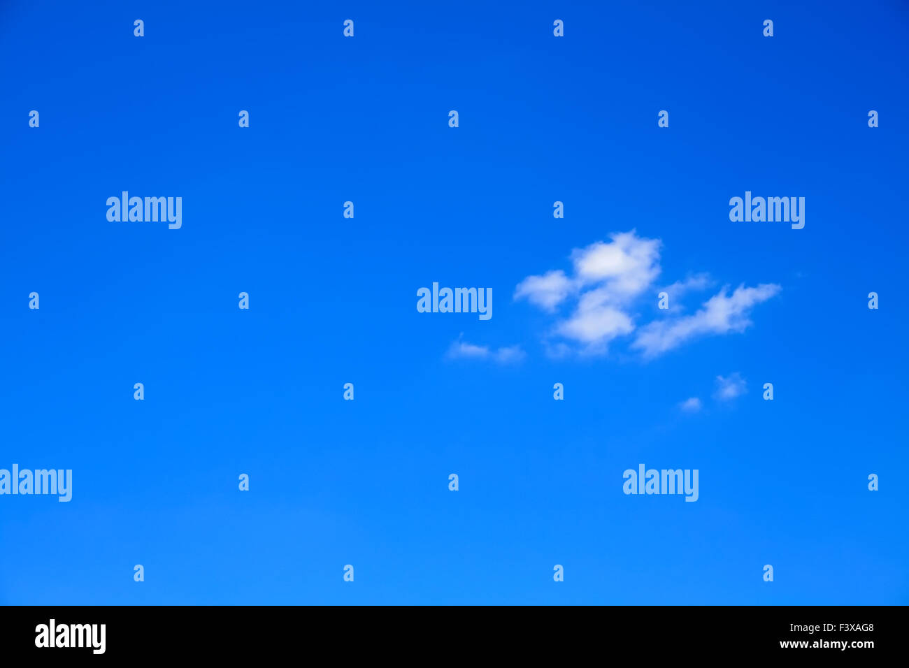Clear blue sky with one little cloud Stock Photo - Alamy