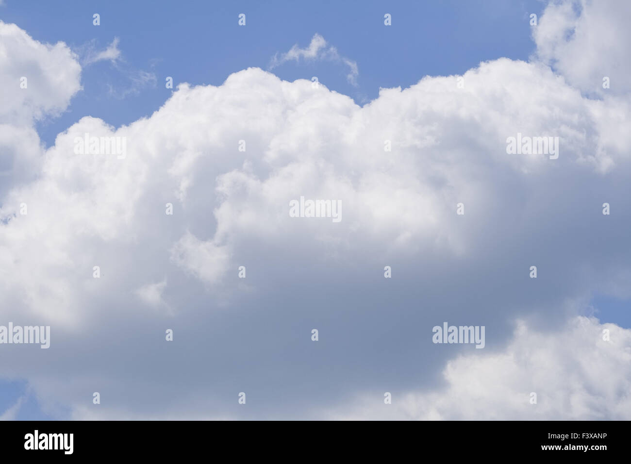 Puffy clouds on blue sky Stock Photo - Alamy