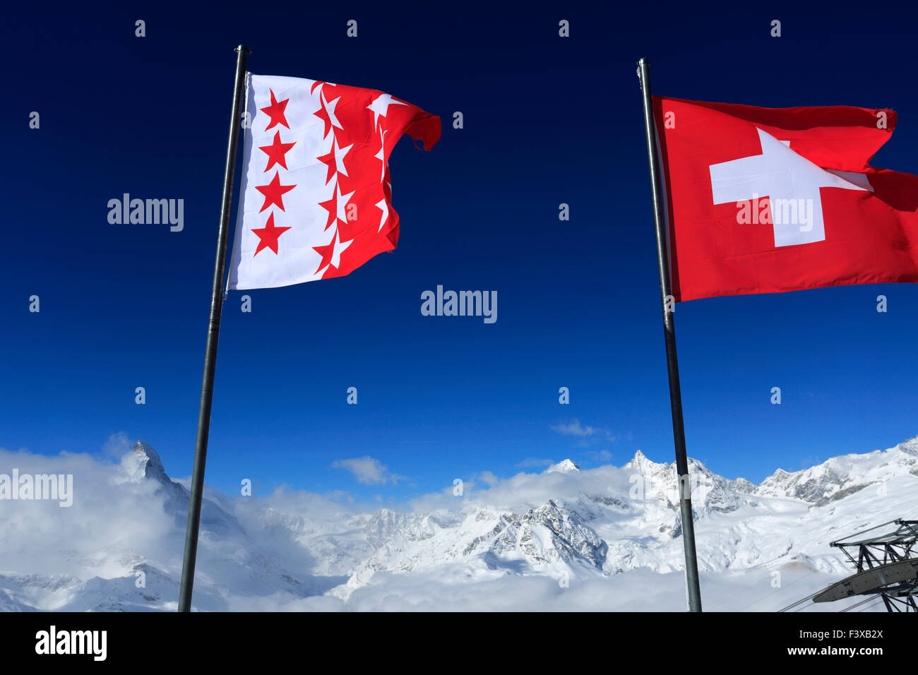 Flag of the Canton du Valais, and the Swiss national flag, Swiss Alps ...