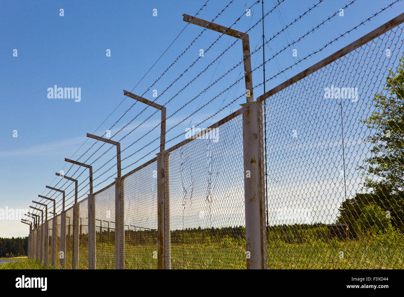 Fence with a barbed wire Stock Photo - Alamy