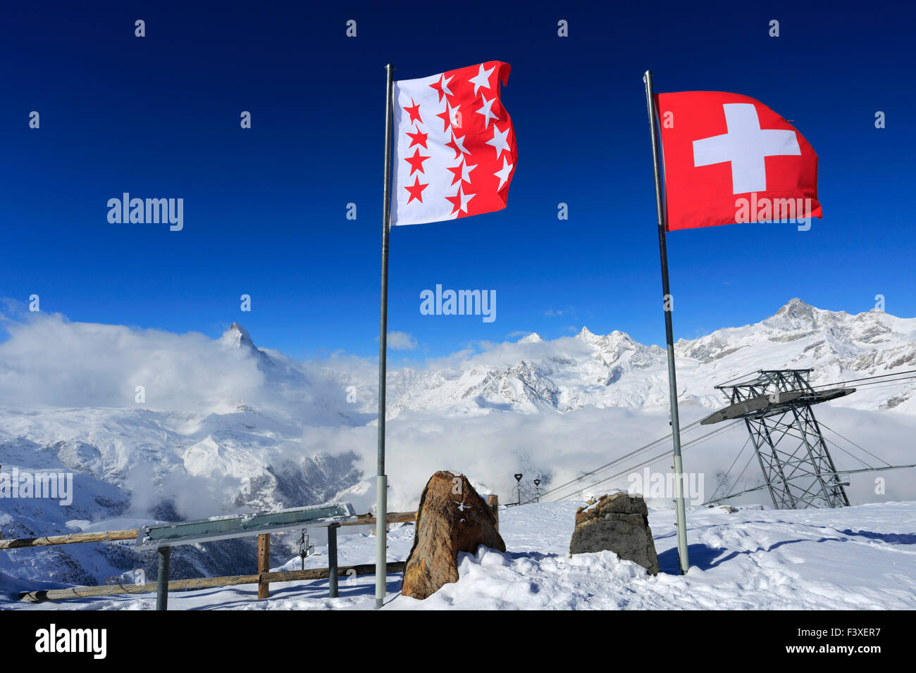 Flag of the Canton du Valais, and the Swiss national flag, Swiss Alps ...