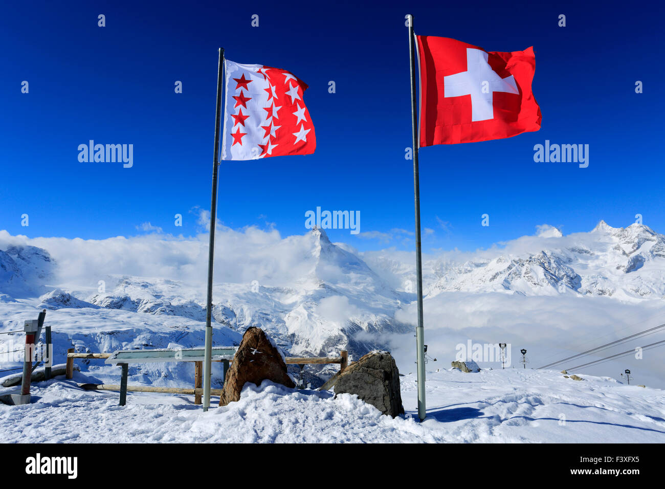 Flag of the Canton du Valais, and the Swiss national flag, Swiss Alps ...
