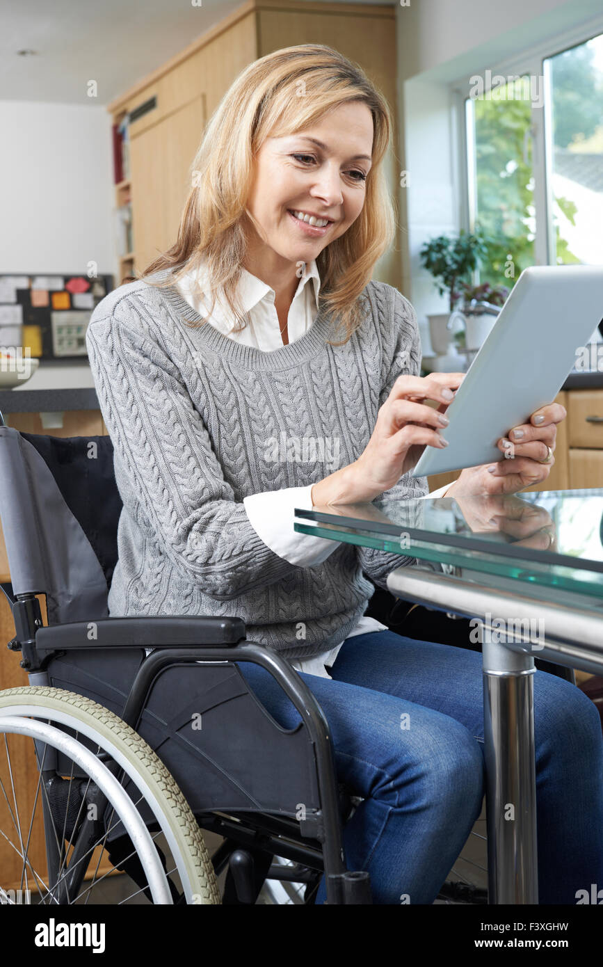 Woman in wheelchair using tablet hi-res stock photography and images ...