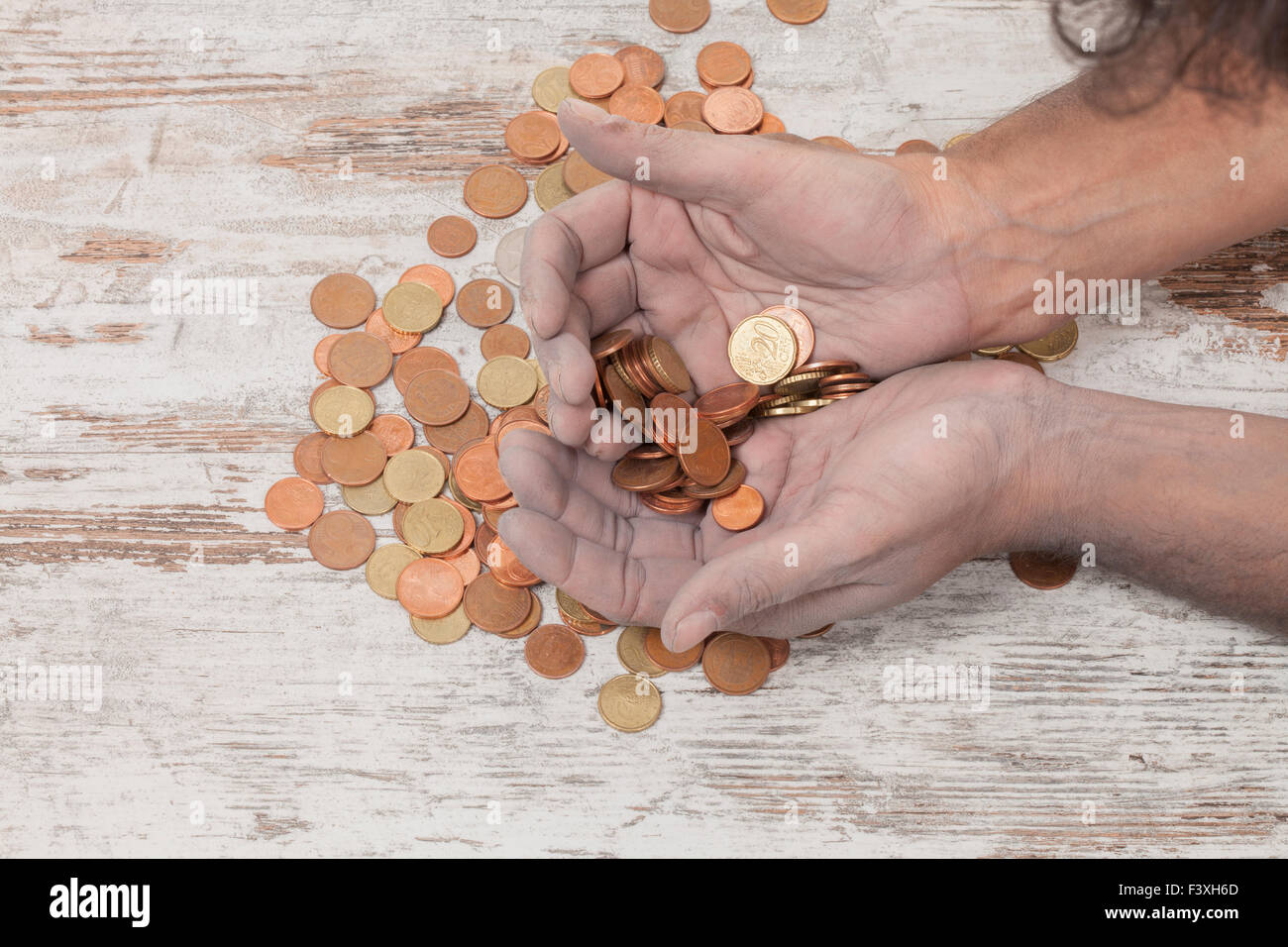 a poor hands taking some coins Stock Photo - Alamy