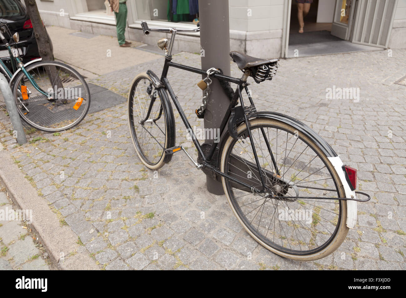 Bicycle parked on pavement Stock Photo - Alamy
