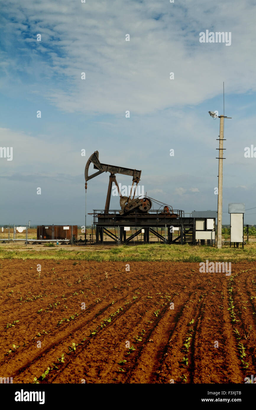 Operating oil and gas well on the meadow Stock Photo - Alamy