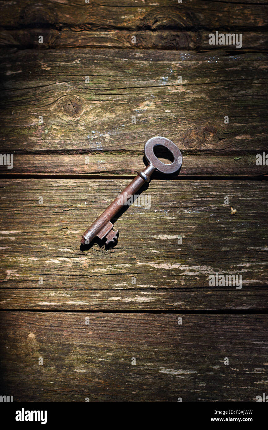 Old key on wood boards Stock Photo - Alamy