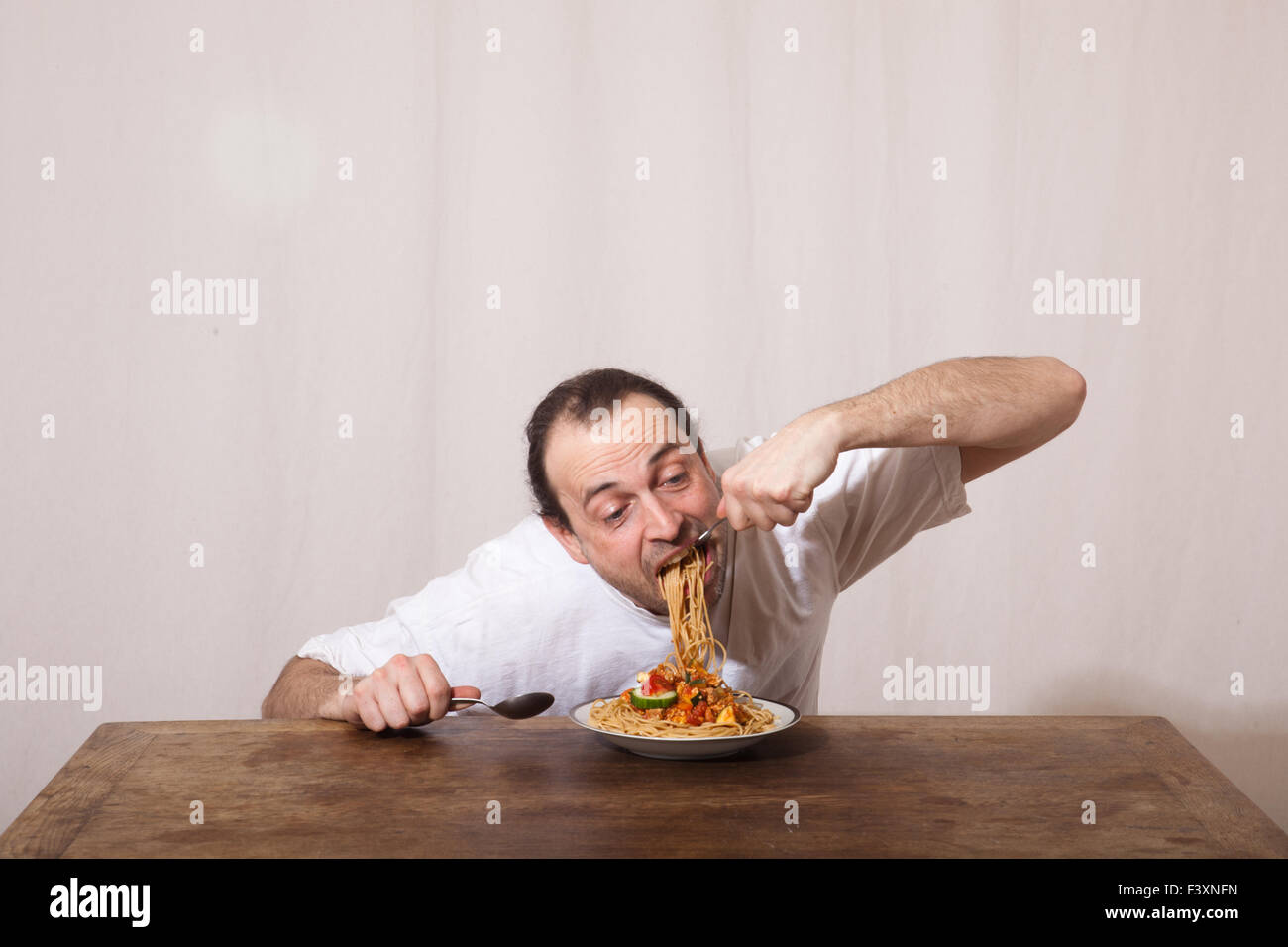 Happy man eating spaghetti hi-res stock photography and images - Alamy