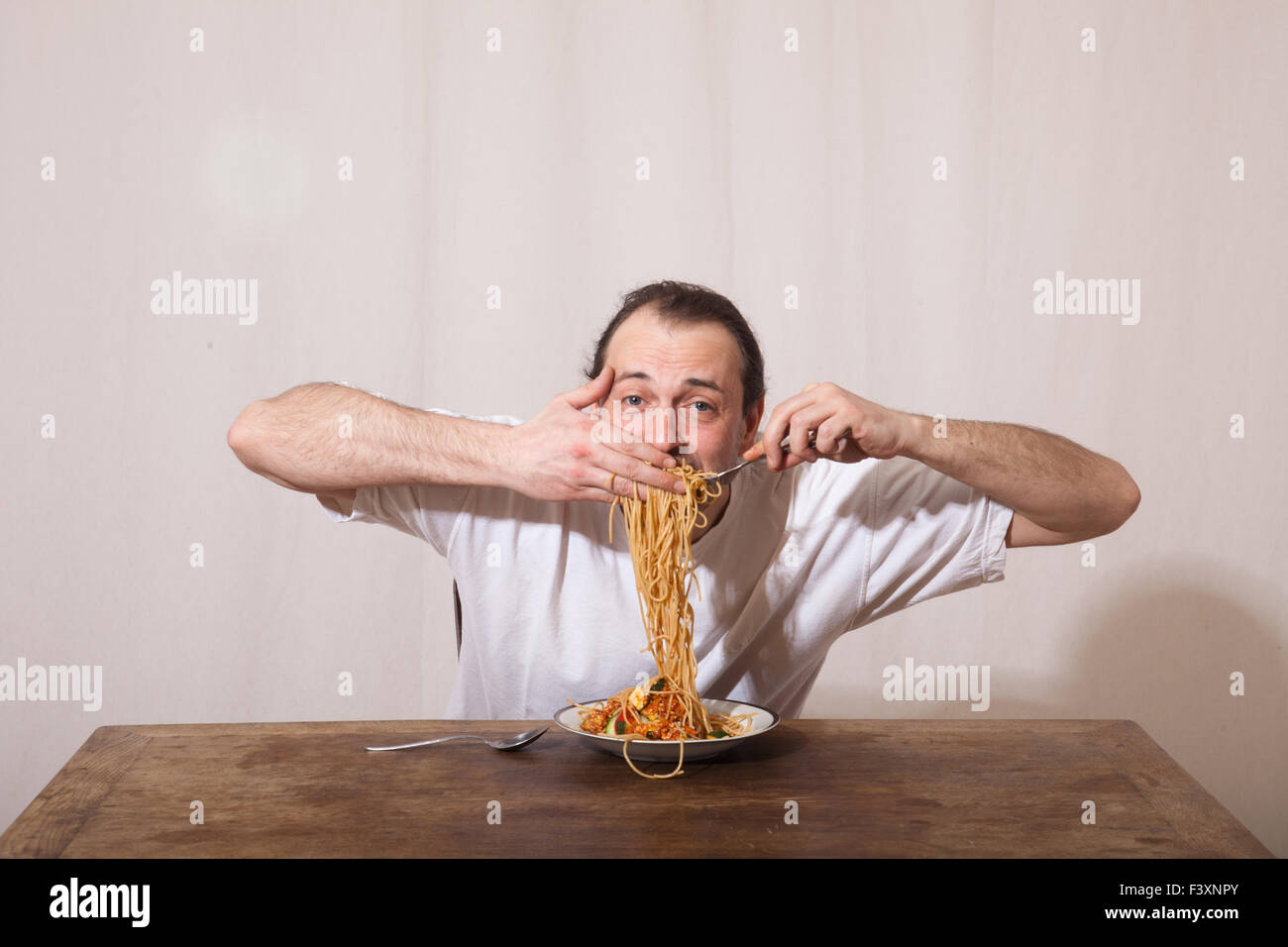 Man Eating Spaghetti With Tomato Sauce High Resolution Stock ...