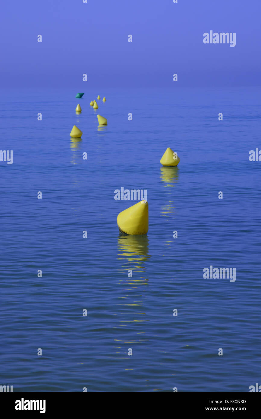 Yellow buoys blue sea Stock Photo - Alamy