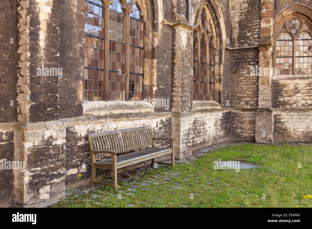 Medieval abbey yard with wooden bench Stock Photo - Alamy