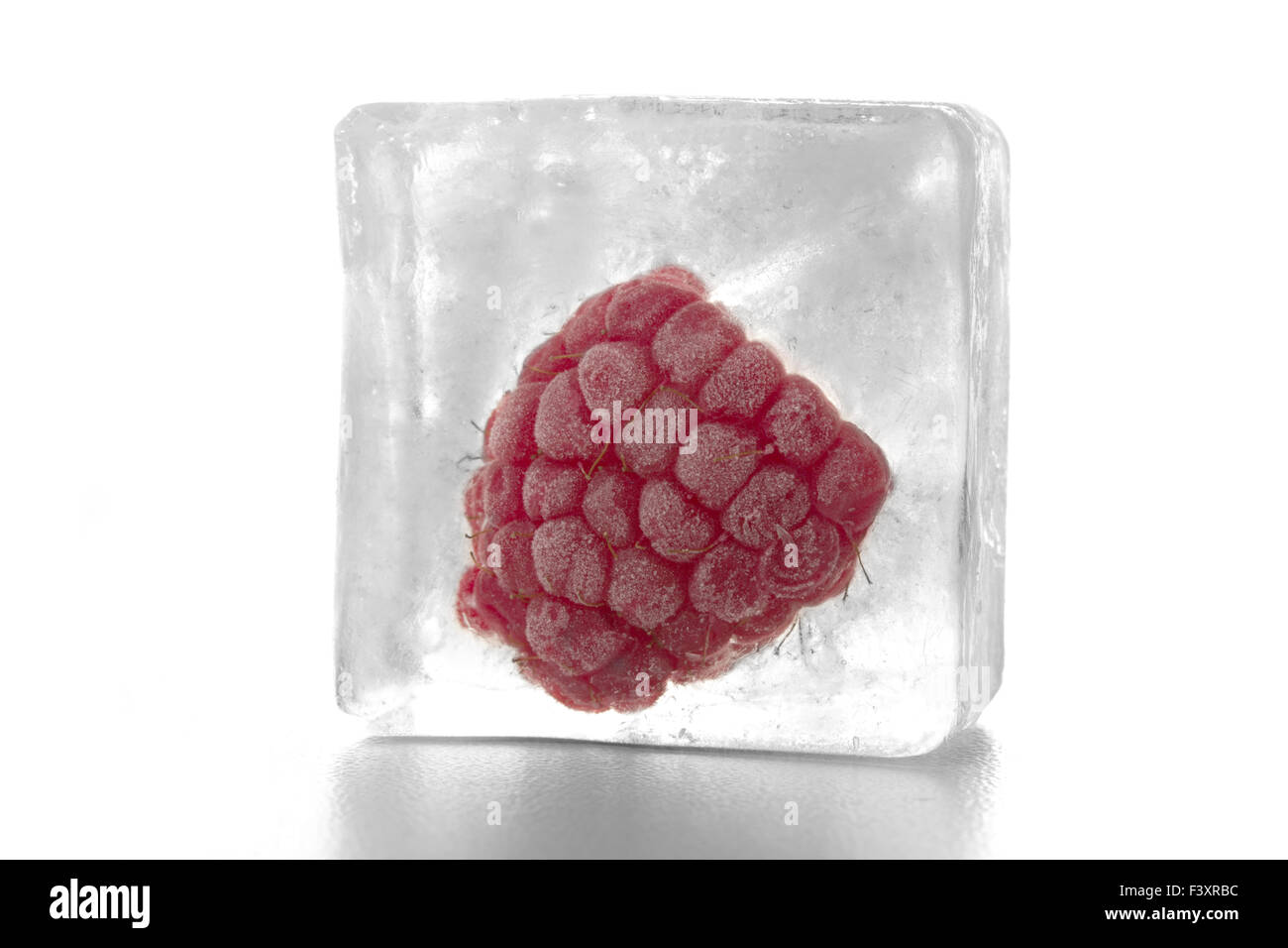 raspberry in a ice cube isolated Stock Photo - Alamy