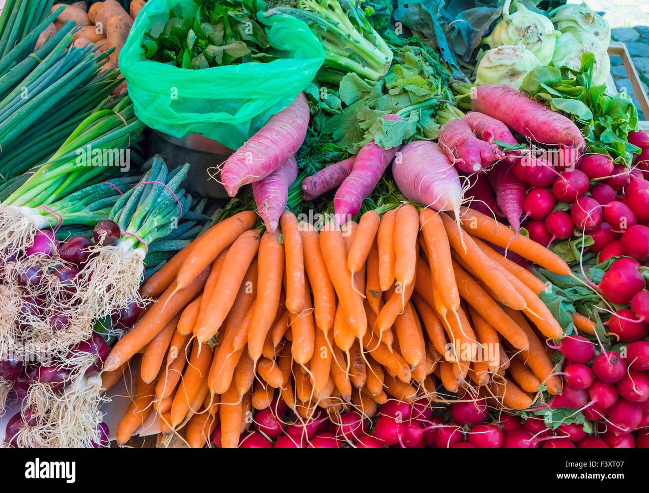 Carrots, radish and herbage for sale at a market Stock Photo - Alamy