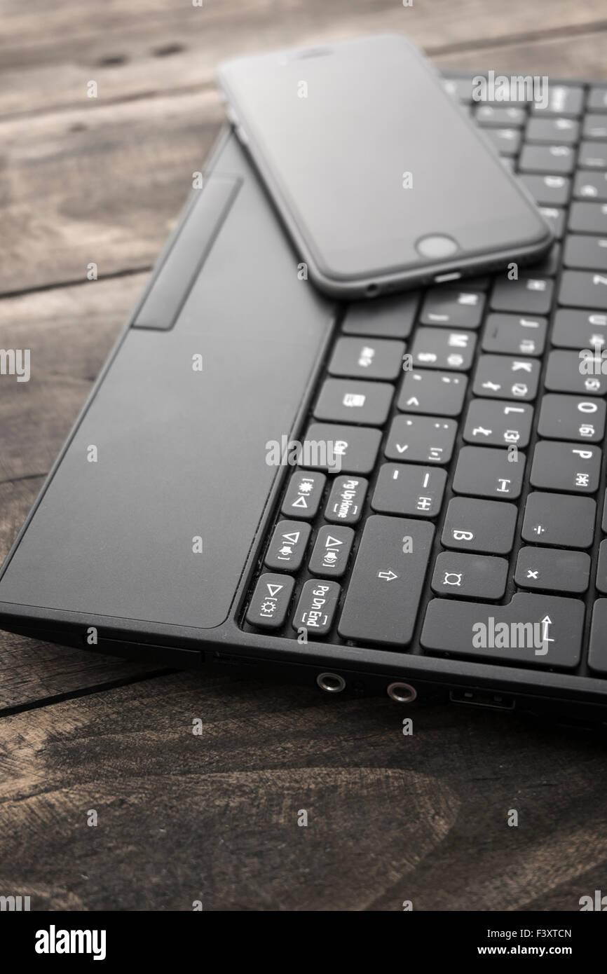 electronic devices on wooden table, close up Stock Photo - Alamy