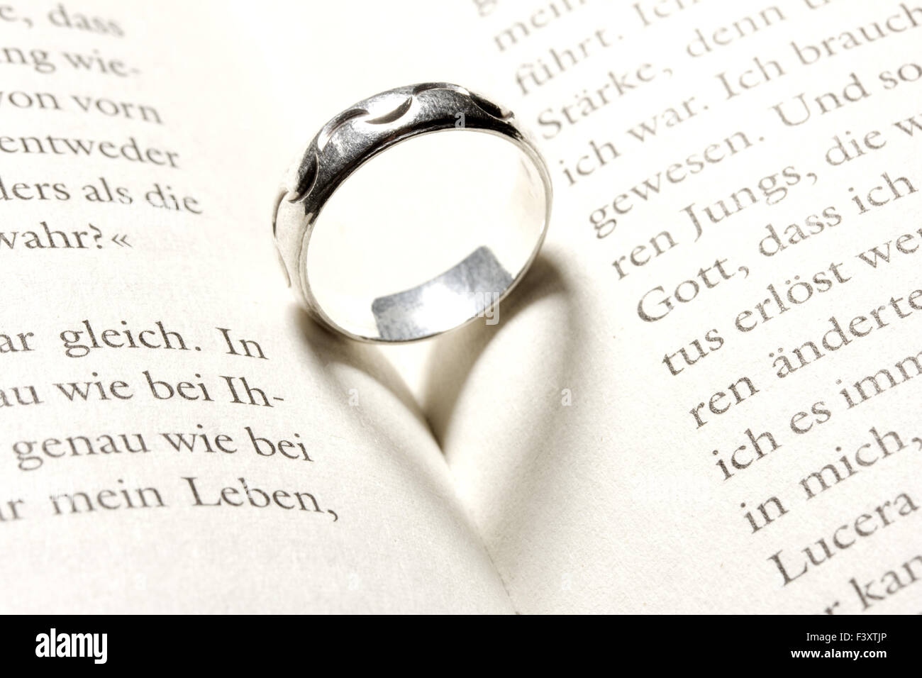 heart in a book by a ring Stock Photo - Alamy