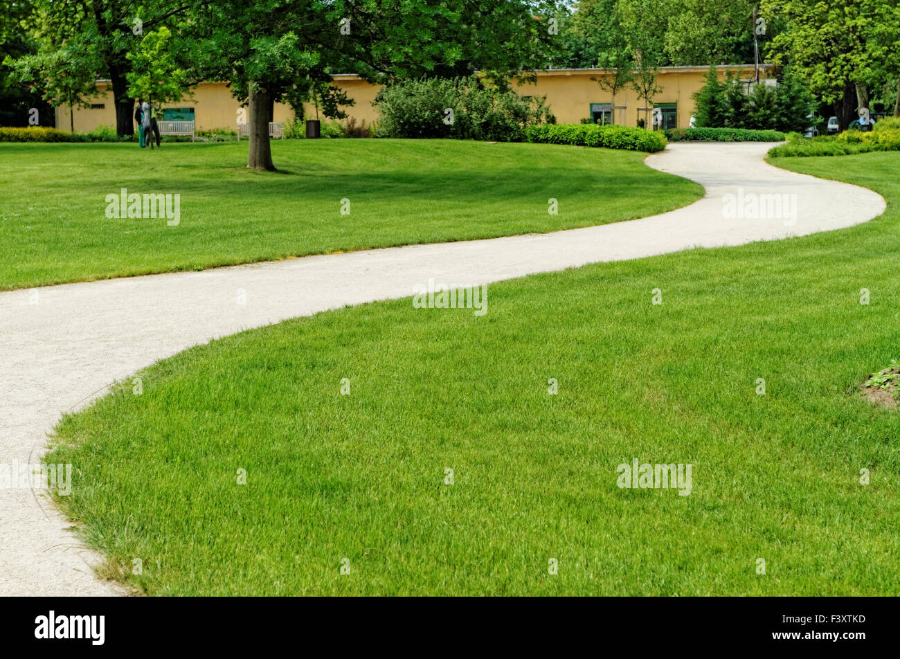 Winding path through a peaceful green garden Stock Photo - Alamy