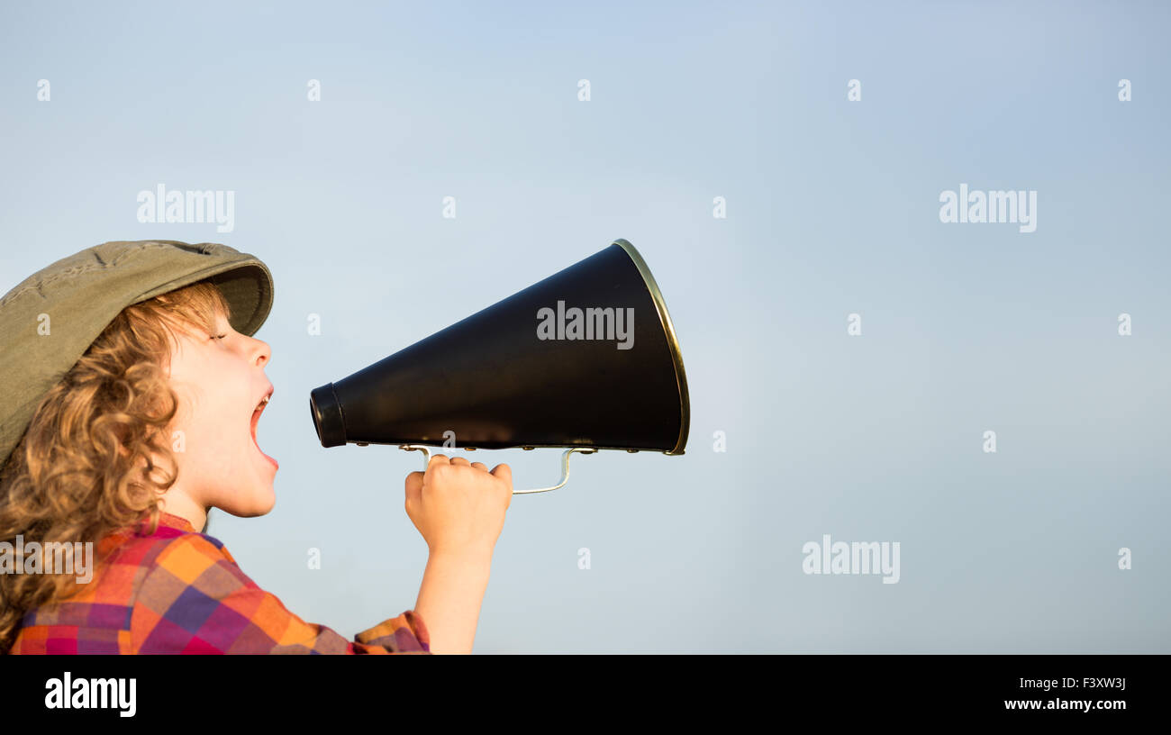 Kid shouting through megaphone Stock Photo - Alamy