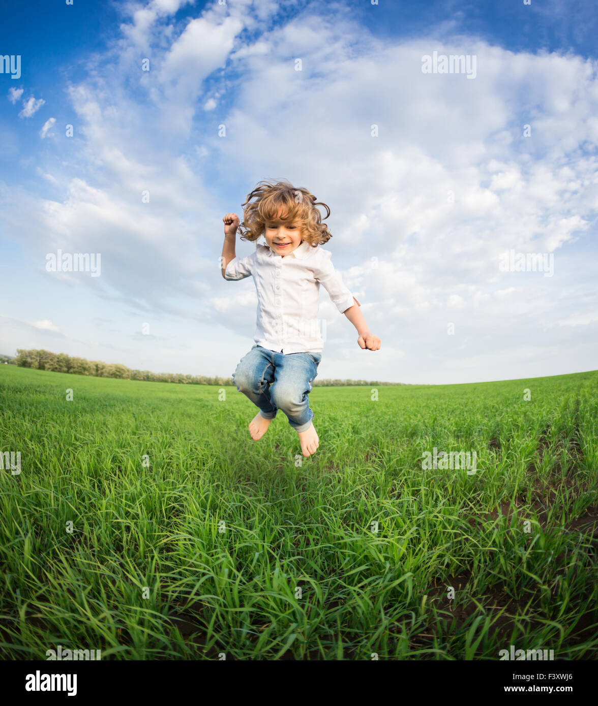 Happy kid jumping Stock Photo - Alamy
