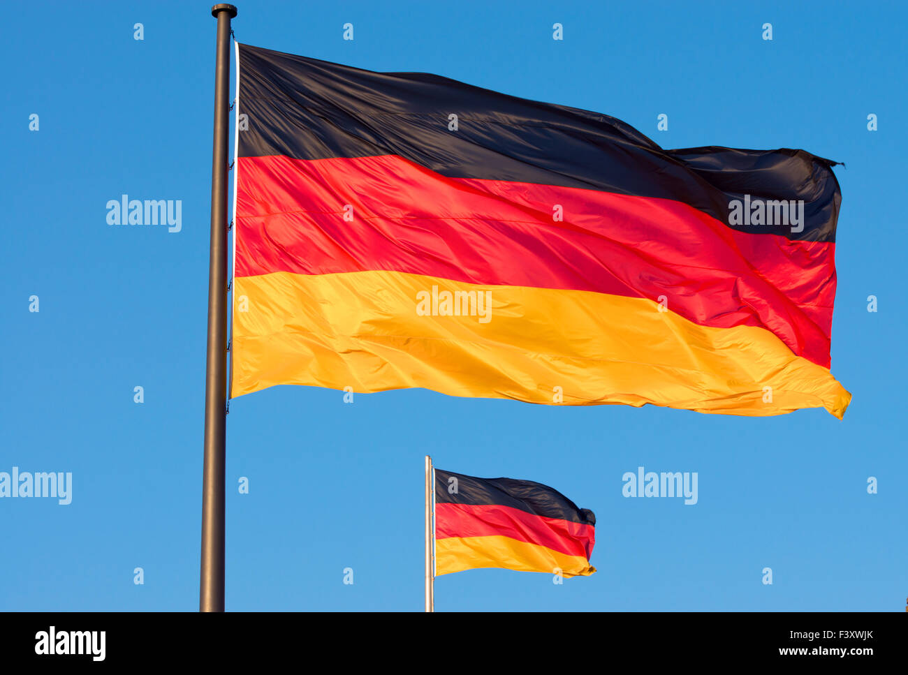 Two german flags flying in a strong wind Stock Photo - Alamy