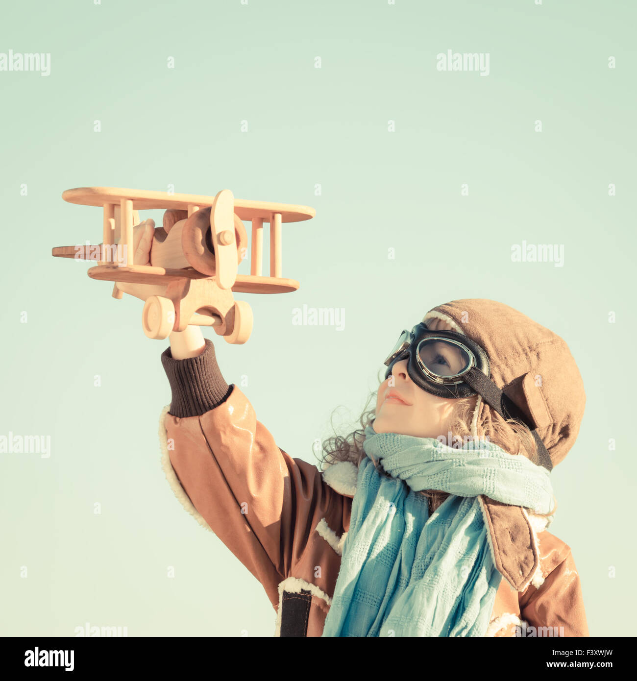 Happy kid playing with toy airplane Stock Photo - Alamy
