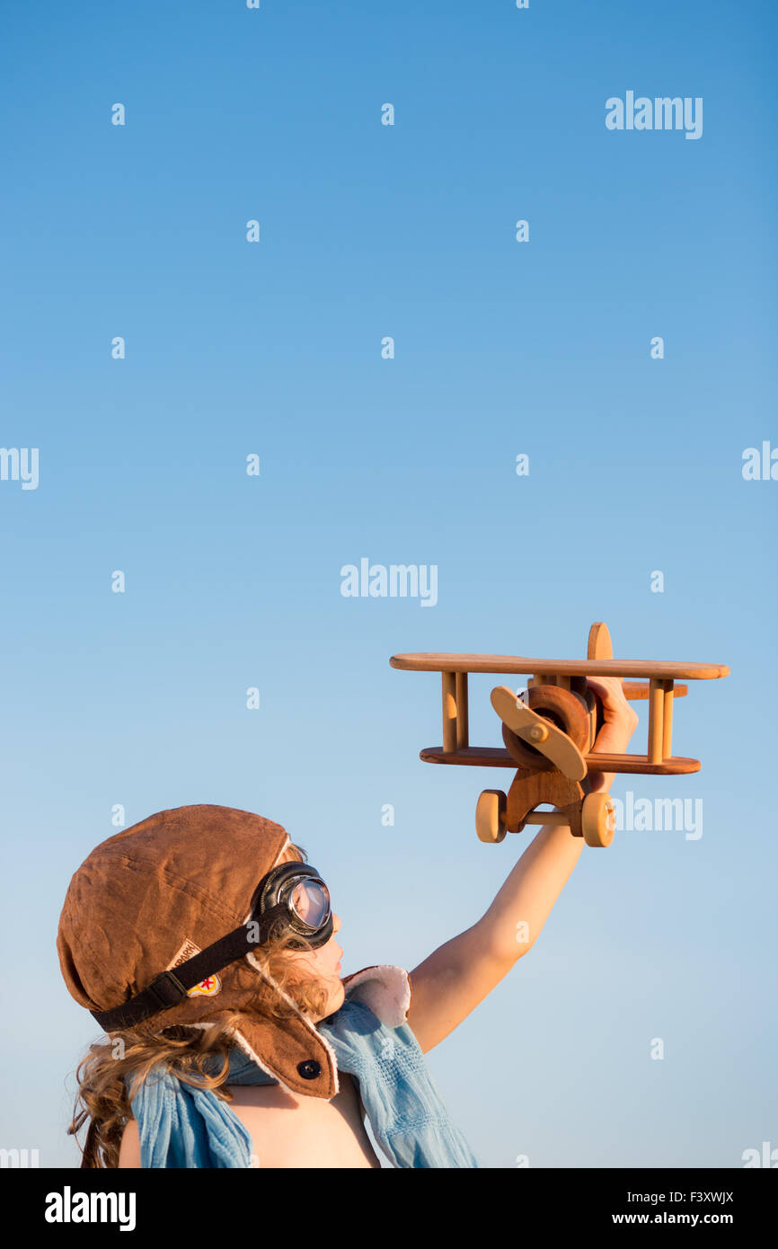 Happy kid playing with toy airplane Stock Photo - Alamy