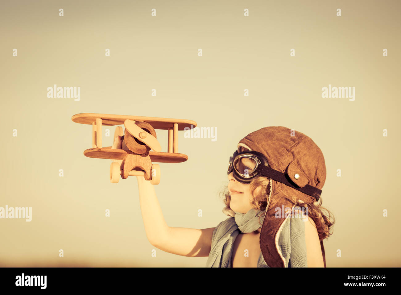 Happy kid playing with toy airplane Stock Photo - Alamy