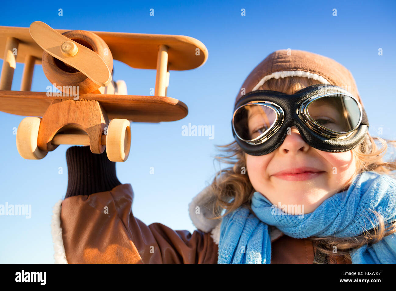 Happy kid playing with toy airplane Stock Photo - Alamy
