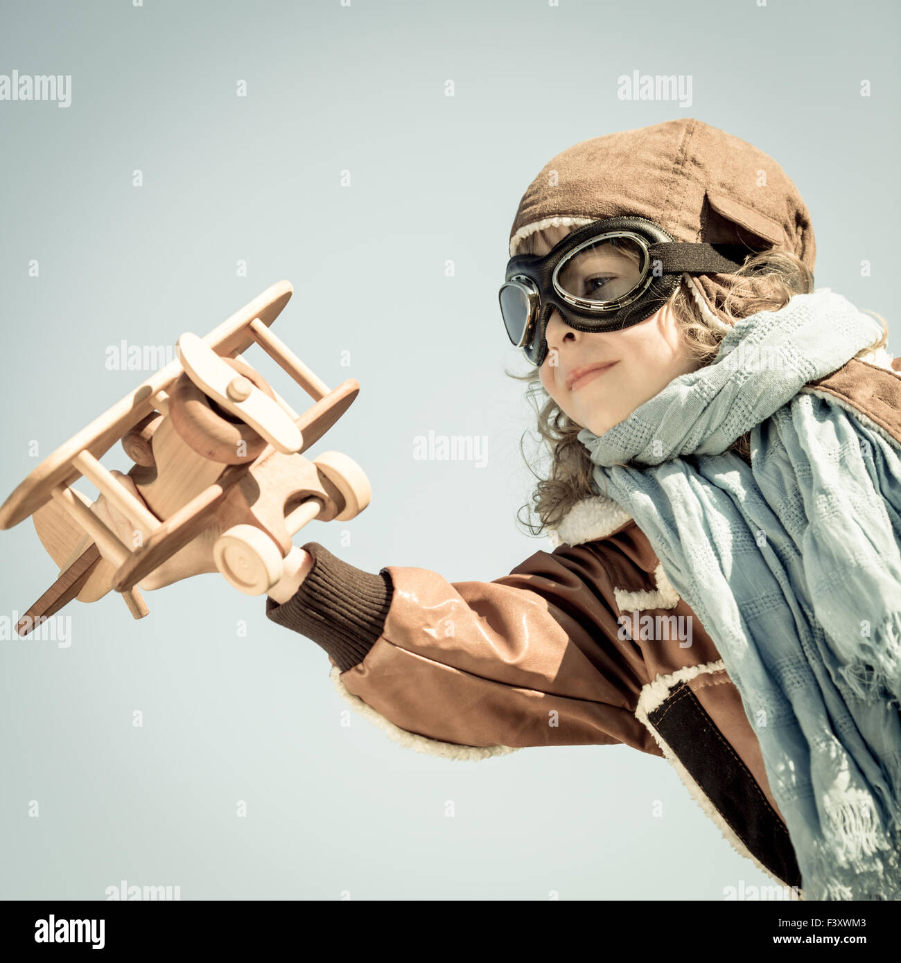 Happy kid playing with toy airplane Stock Photo - Alamy