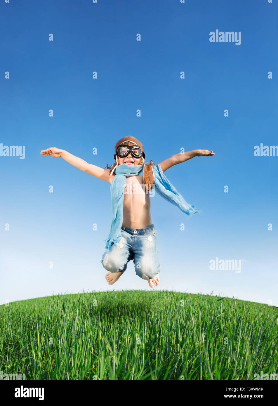 Happy kid jumping outdoors Stock Photo - Alamy