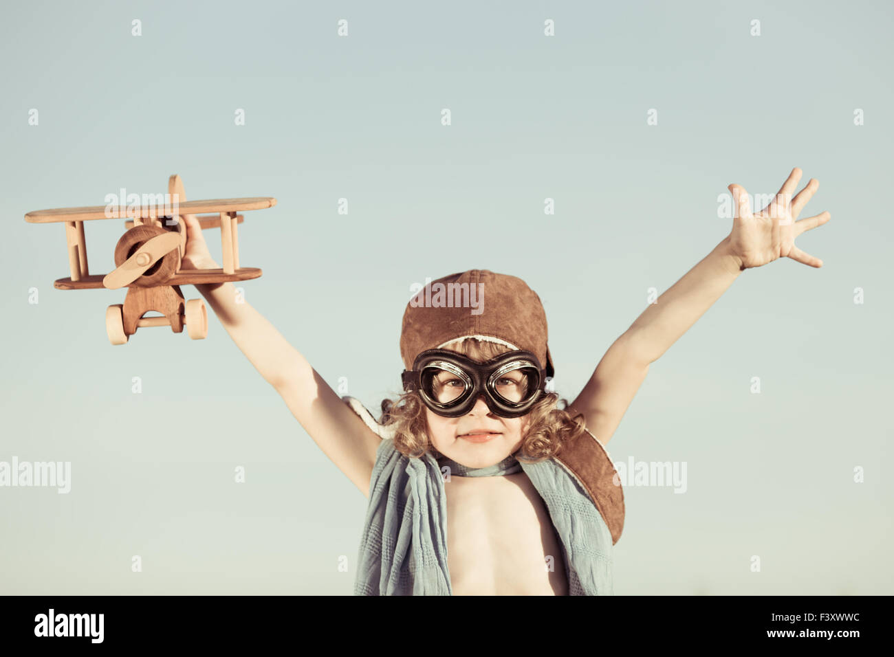 Happy kid playing with toy airplane Stock Photo - Alamy