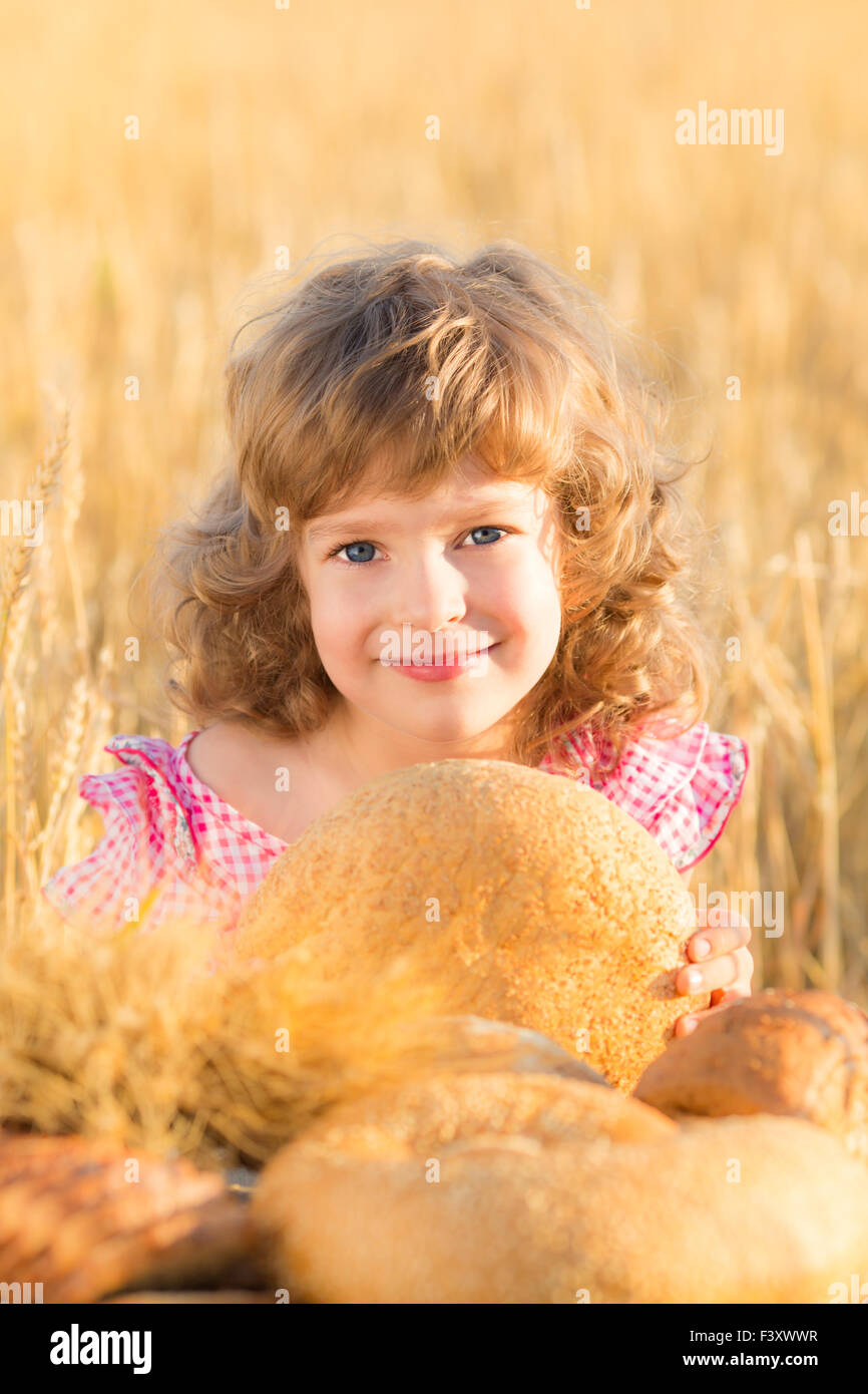 Happy child holding bread Stock Photo - Alamy
