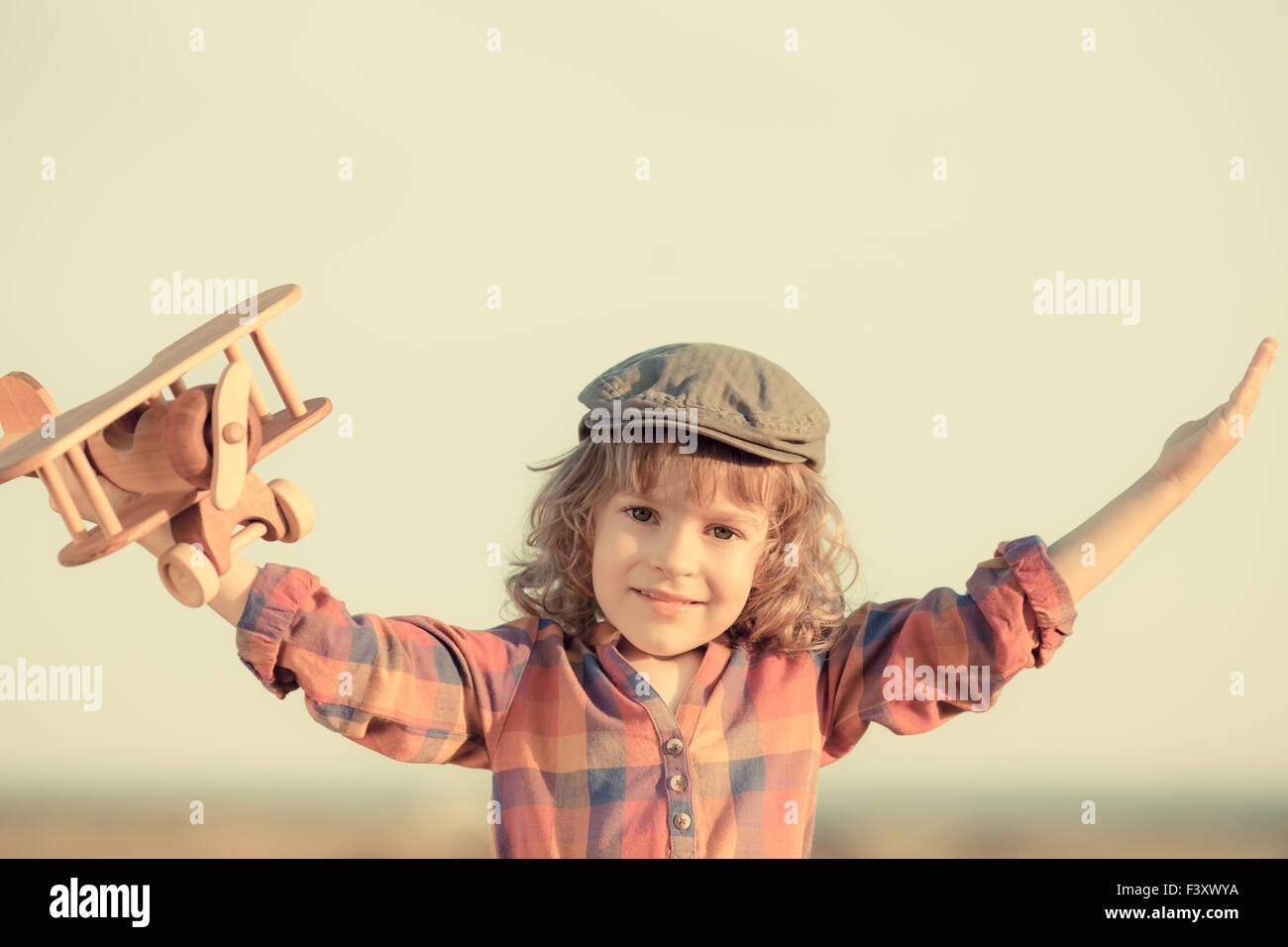 Happy kid playing with toy airplane Stock Photo - Alamy