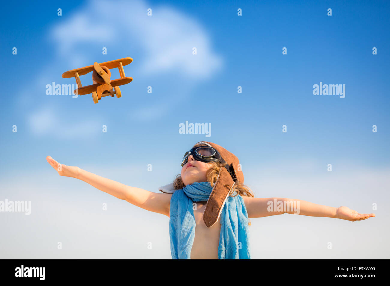 Happy kid playing with toy airplane Stock Photo - Alamy