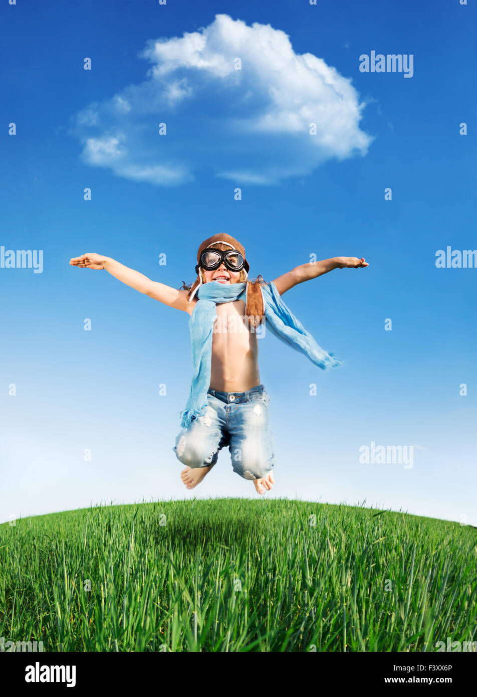 Happy kid jumping outdoors Stock Photo - Alamy
