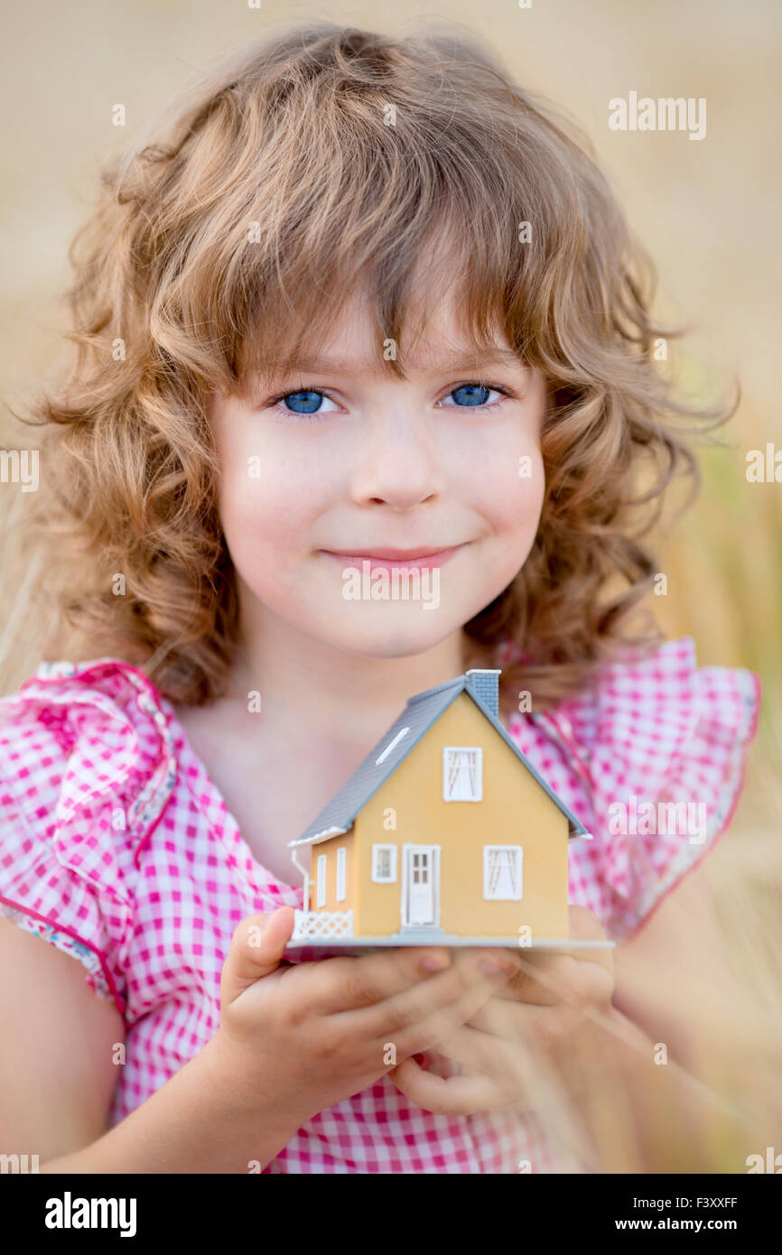 Child holding house in hands Stock Photo - Alamy